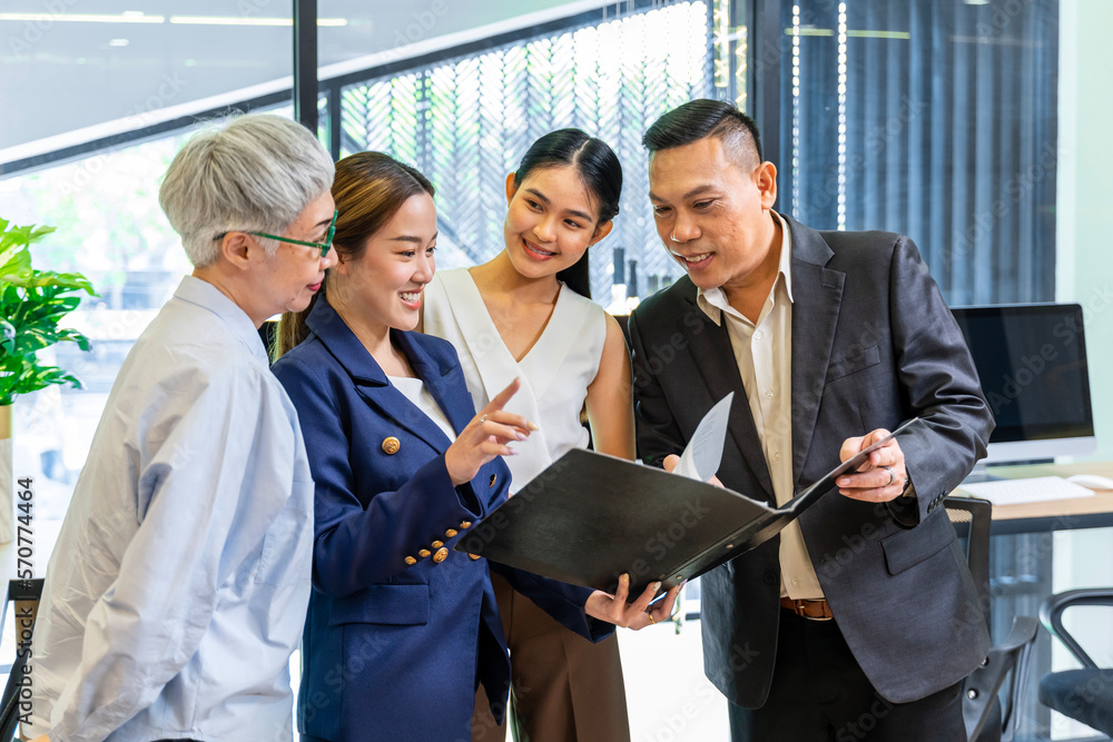 Team of Asian people with different age group brainstorming on data and ...