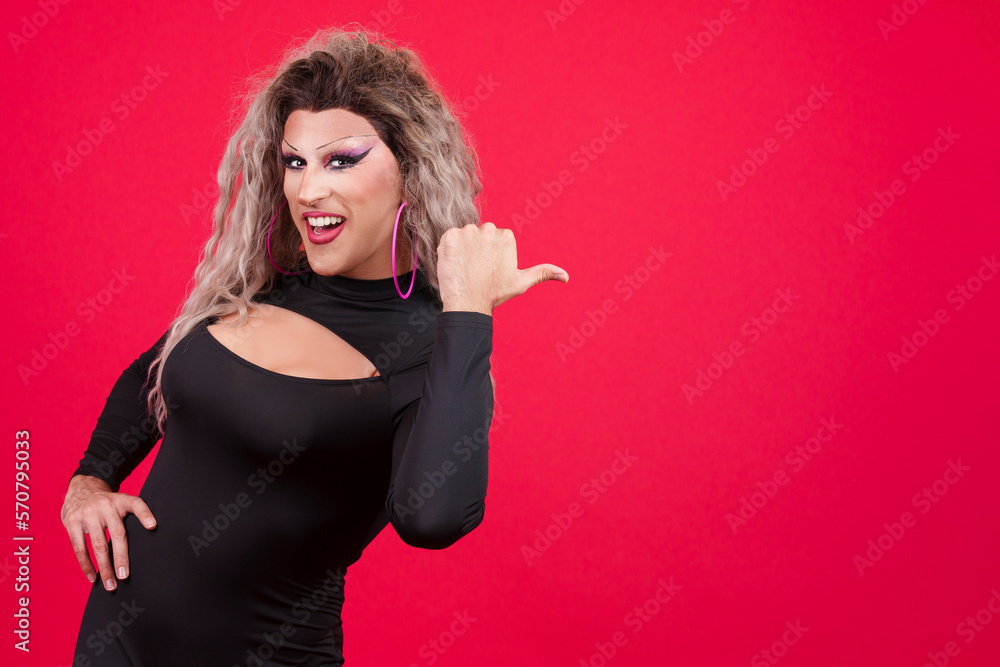 Transgender person smiling at camera and pointing to the side Stock ...