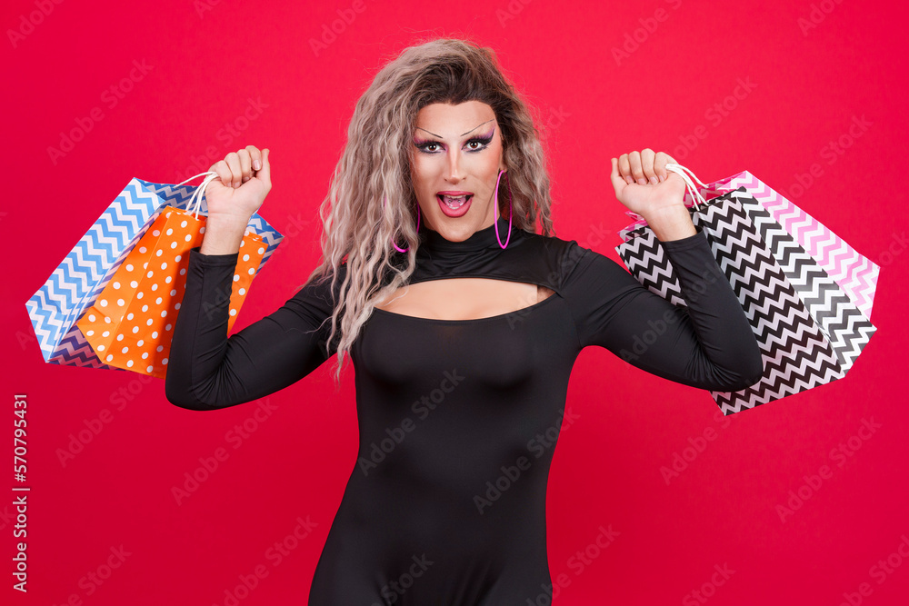Transgender person smiling at the camera while showing shopping bags ...