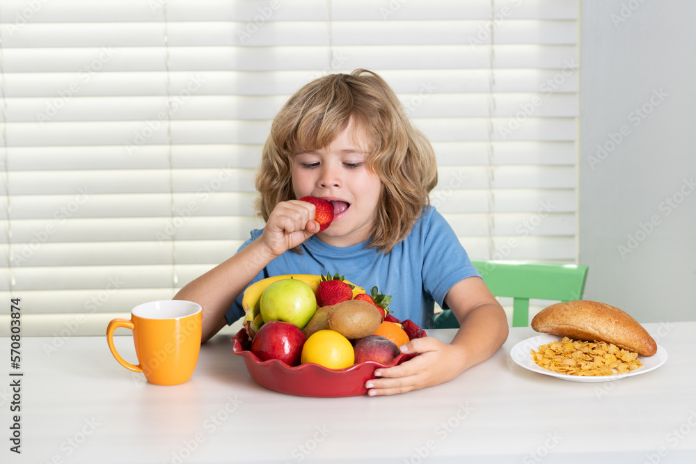 Child eats strawberry, organic fruits. Portrait of preteen child eat ...