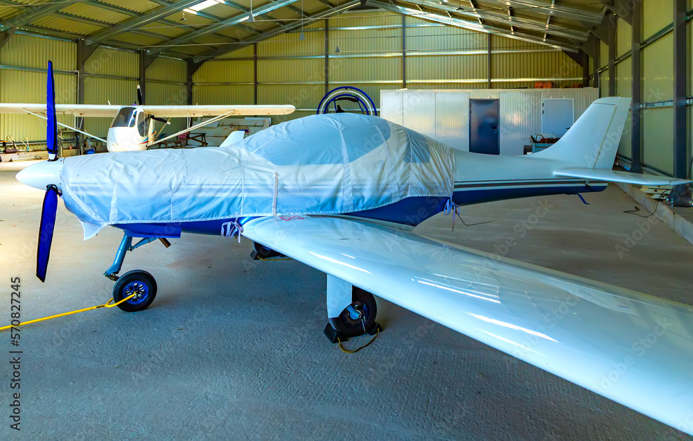 small plane with athree bladed propeller of private aviation is covered ...
