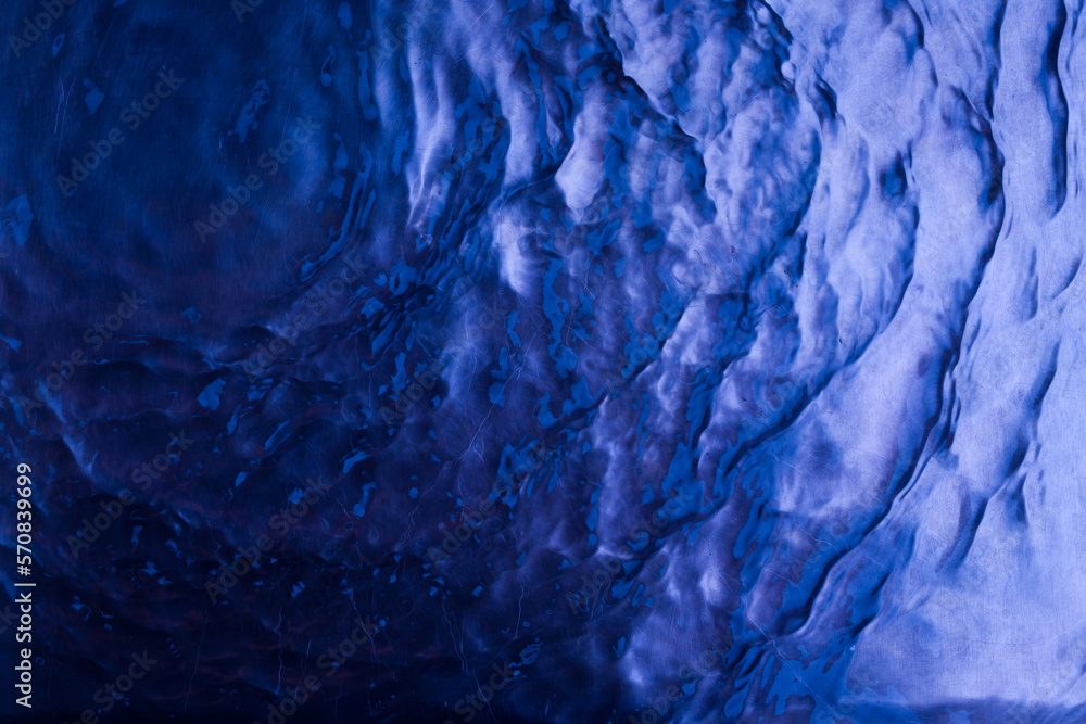 dark blue water surface texture with ripples and splashes. Abstract ...