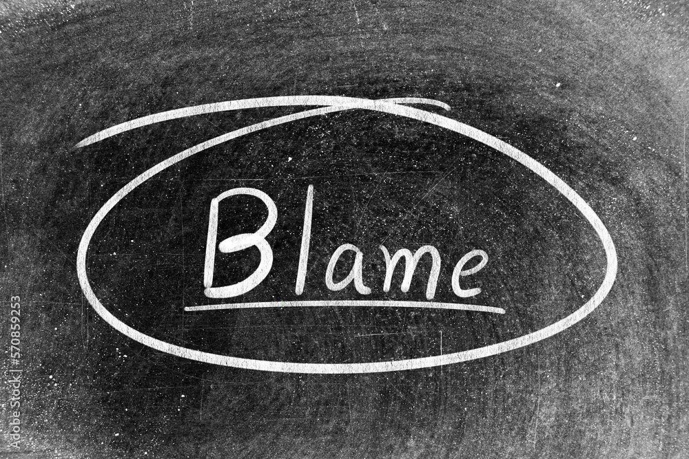 White chalk hand writing in word blame and circle shape on blackboard ...