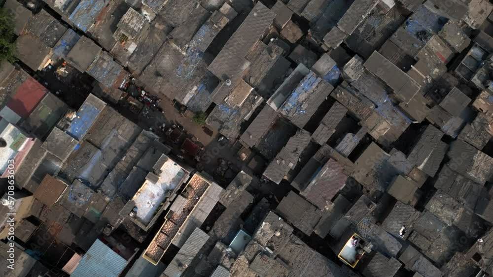 Top down aerial view rotating over Dharavi slums in Mumbai, Maharashtra, India. Dharavi is ...
