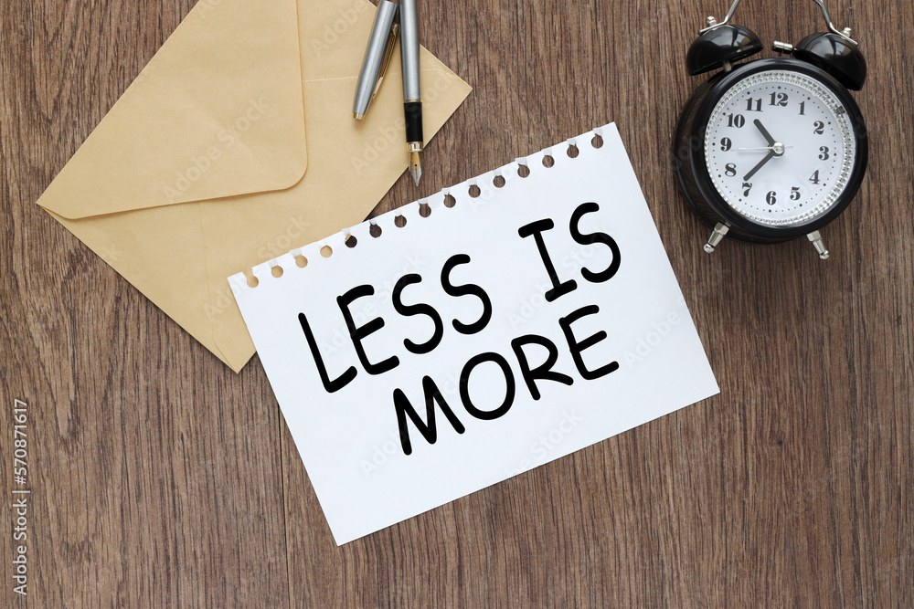 Less is more business concept . wooden background. sheet of paper and ...