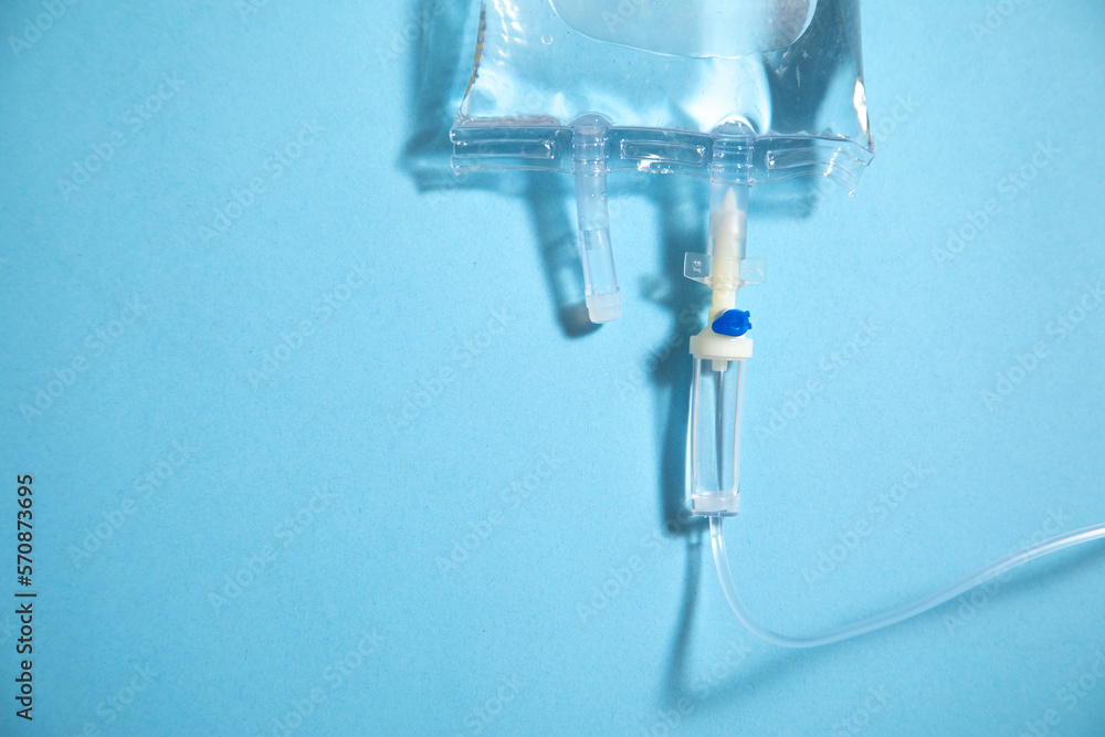 Infusion bag in the blue background. IV drip chamber Stock Photo ...