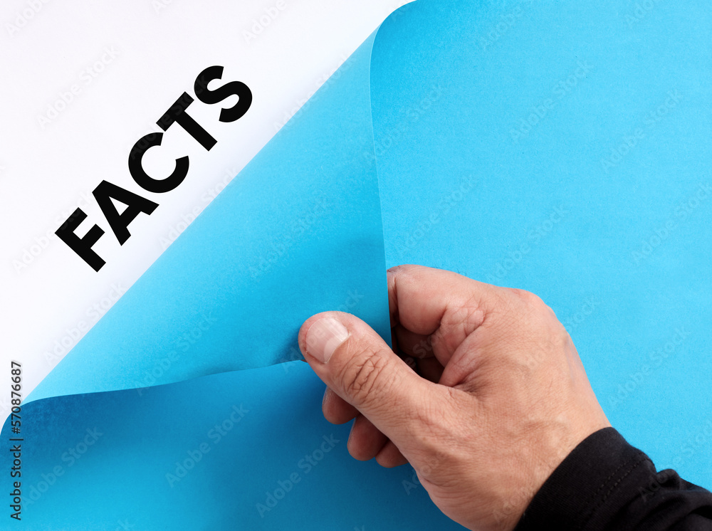 To uncover facts and finding the truth. Male hand opens the blue paper ...