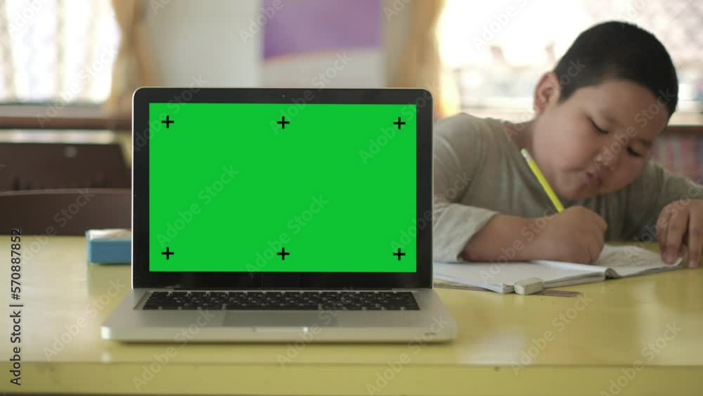 Chroma key green screen laptop computer set up for work on wooden desk ...