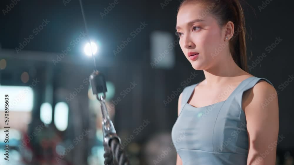 Asian Woman fitness exercises at gym lat pulldown machine.Making an ...