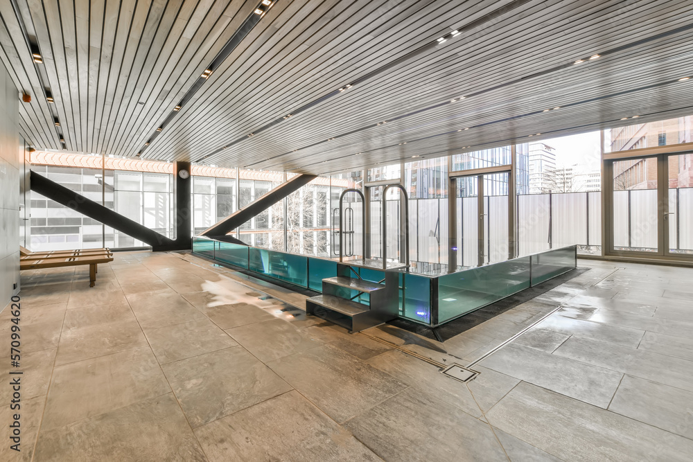 Swimming pool with steps in hotel building Stock Photo | Adobe Stock