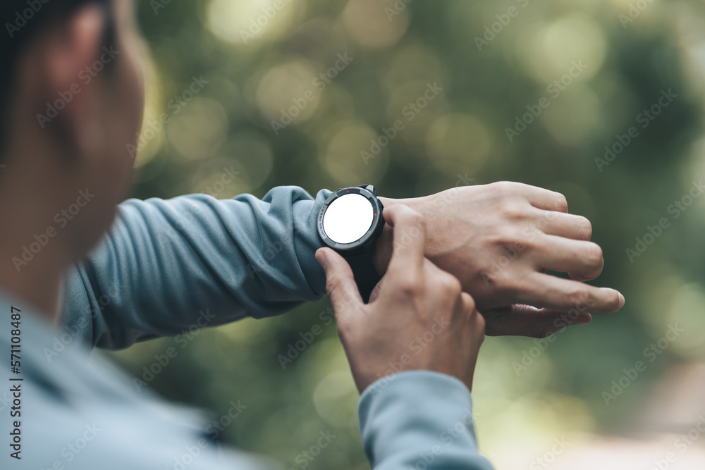 sport man checking at smartwatch during training and running in the ...