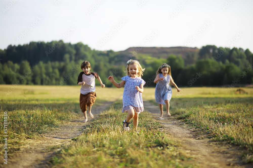Children walk in the summer in nature. Child on a sunny spring morning ...