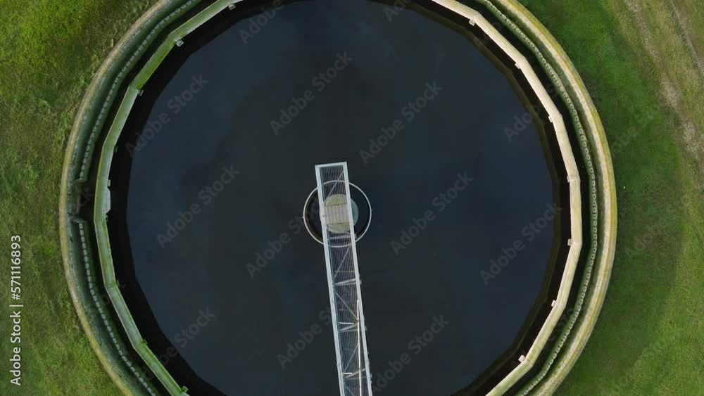 Aerial establishing view of water basins at sewage treatment plant ...