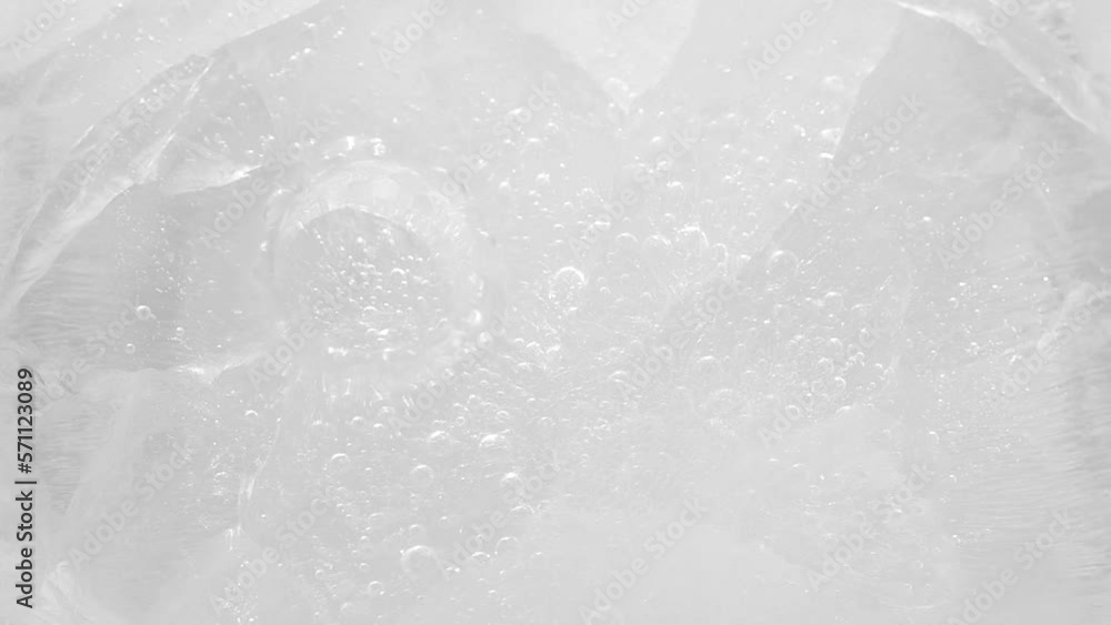 Macro crushed ice texture with splashing water surface, water drops and ...