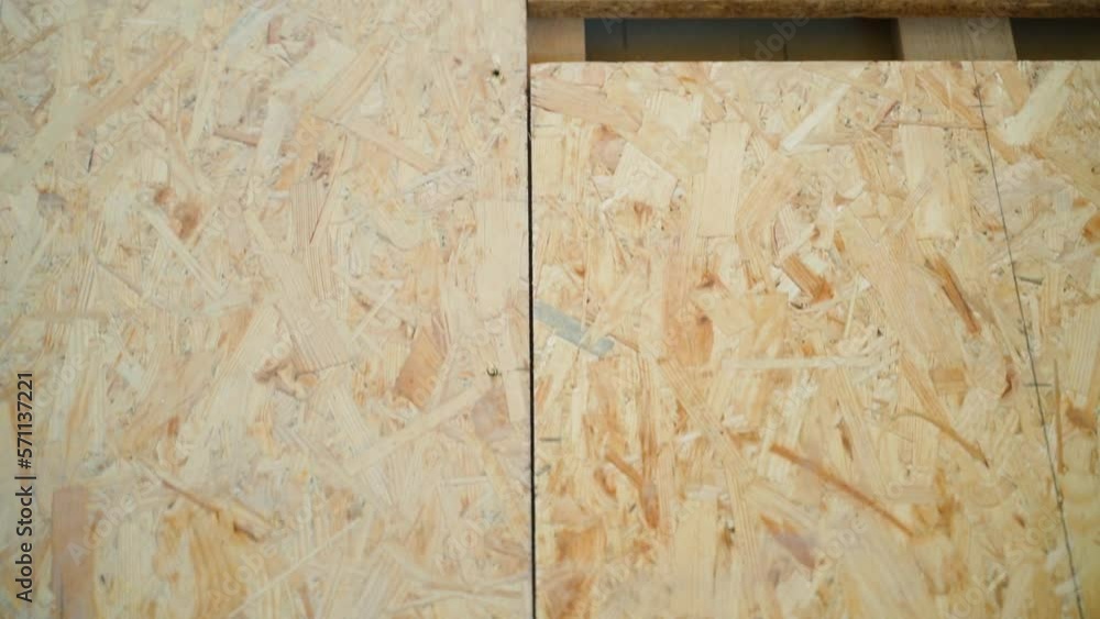 Draft floor of OSB panels, top view. Oriented strand board bolted to the floor, smooth camera ...