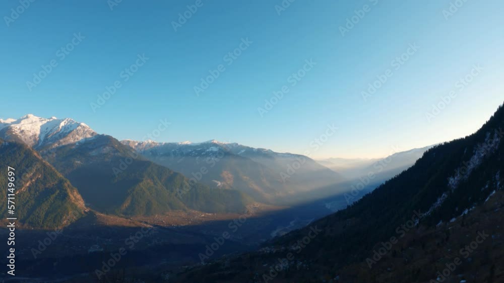 Sun rays coming through the mountains of the Himalayan mountain range ...