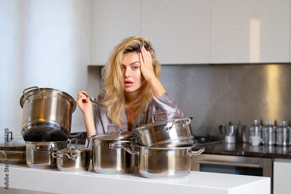 Bored young woman cooking. Woman at home in morning. Beautiful female ...