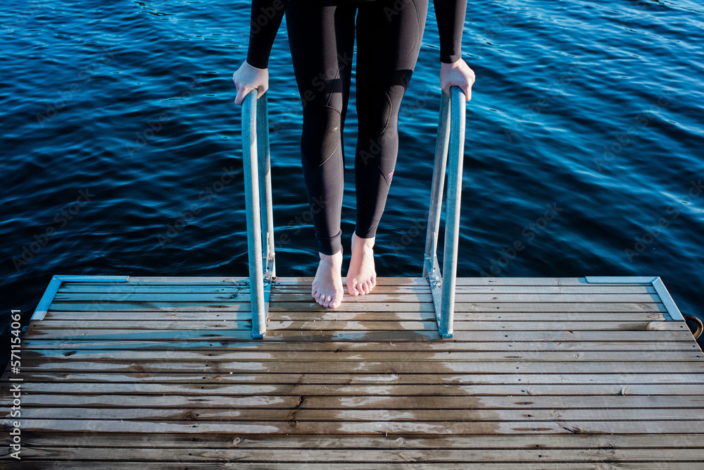 woman's feet standing on steps down to cold water for swimming Stock ...