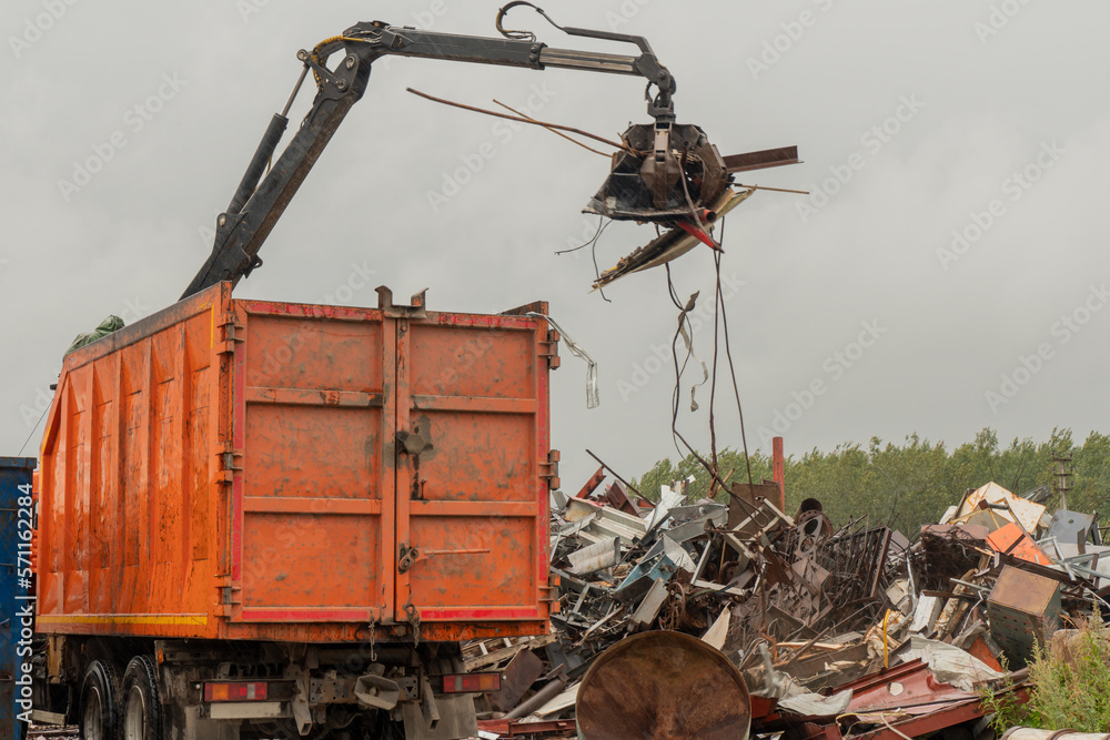 Loading of scrap metal by hydraulic crane, for recycling. Stock Photo ...
