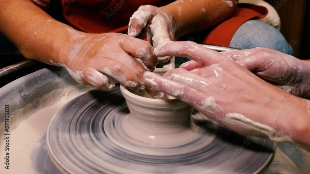 Vídeo do Stock: A female potter's expert hands bring a lump of clay to ...