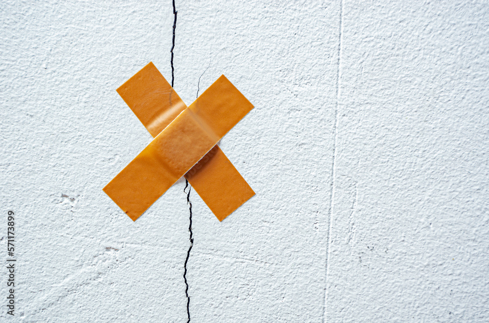 The band-aid plaster on a crack in the home wall. Cracks in the wall ...
