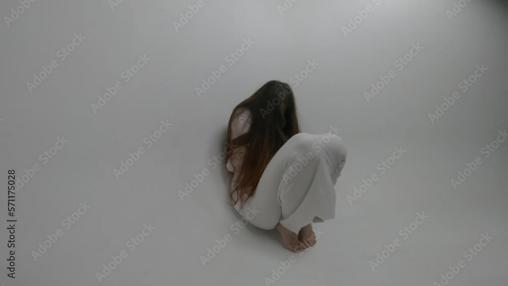 Cinematic footage of girl with face covered with long red hair, dressed ...