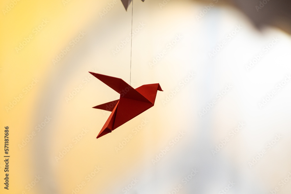 Japanese folded Origami cranes hanging on with strings. Hundreds ...