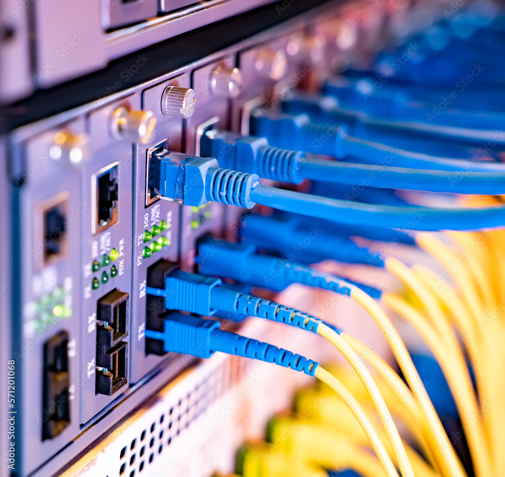 Fiber Optical cables connected to an optic ports and Network cables ...