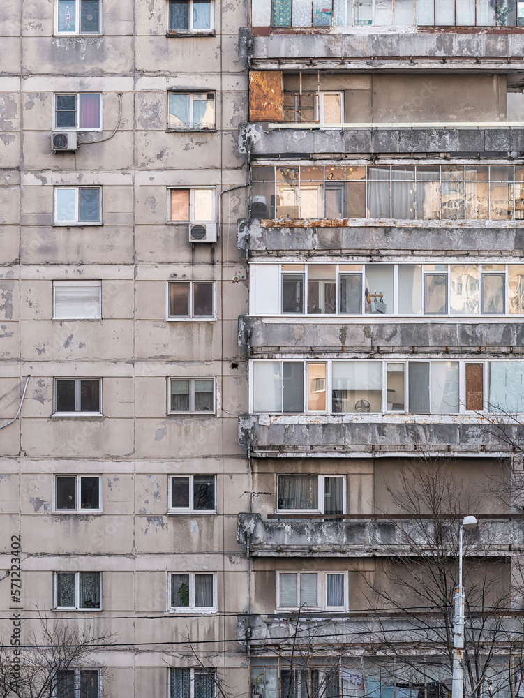 Worn out apartment building from the communist era against blue sky in ...