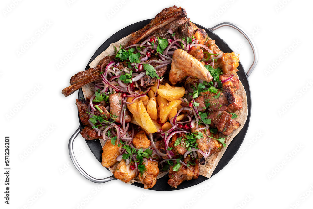 Assorted grilled meat with herbs and potatoes on a large plate. Pieces ...