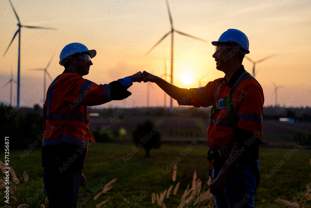 technician working outdoor at wind turbine field. Renewable energy ...