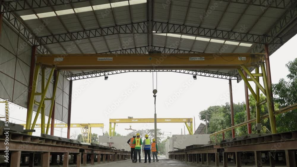 Engineers are inspecting work inside a precast concrete factory ...