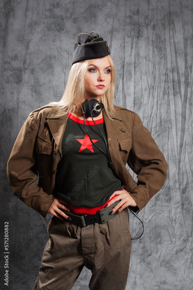 A strict blonde in a military outfit, a Khaki suit with breeches and a ...
