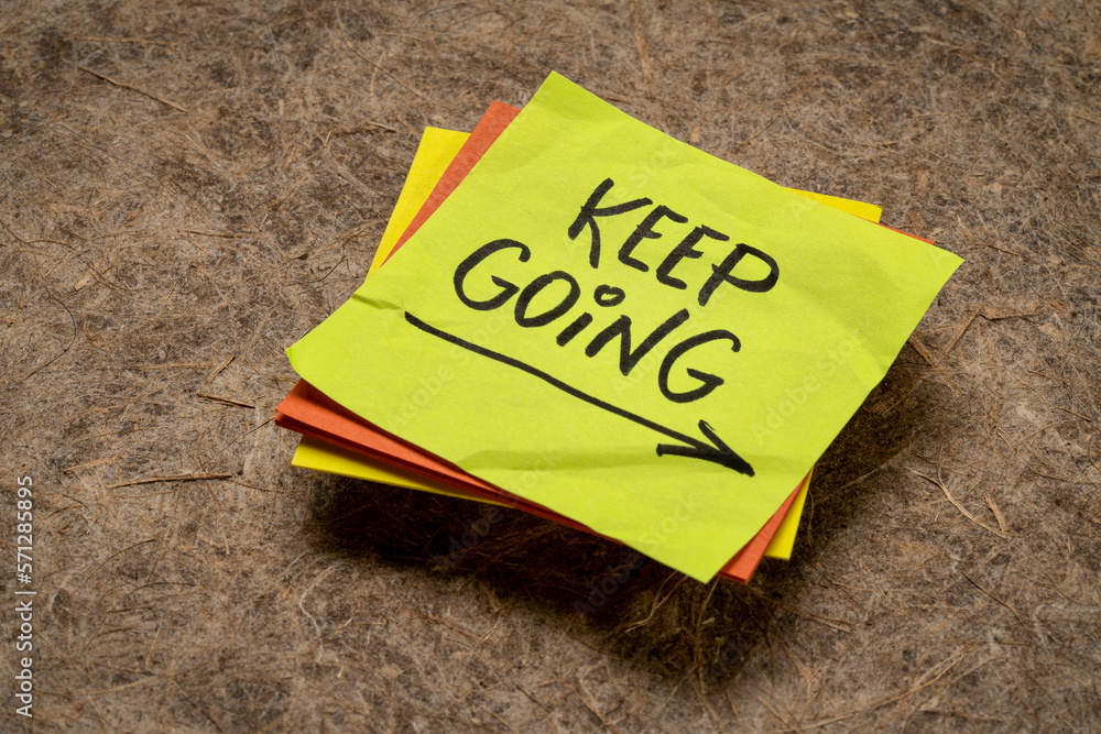 keep going - motivation or determination concept - handwriting on a ...