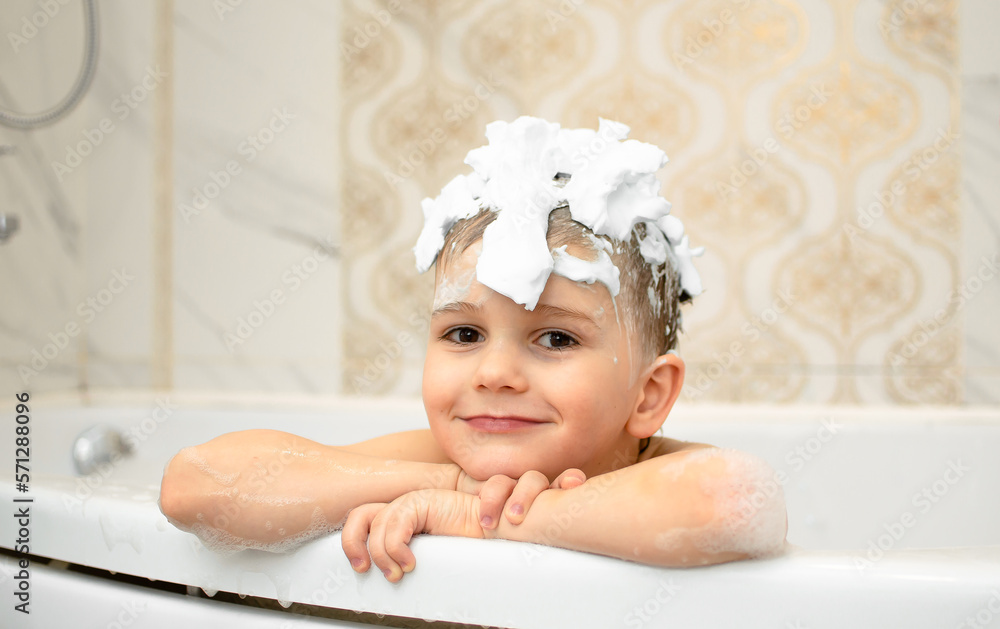 Charming child with soap foam on her hair takes bath. Portrait of ...
