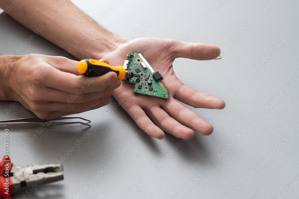 Robot arm concept. Man shows biomechanical prosthetic hand. Guy repairs ...
