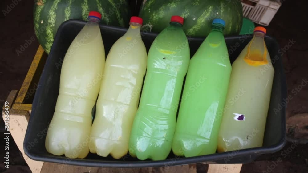 Closeup of plastic bottles with manioc tucupi sauce, yellow broth ...
