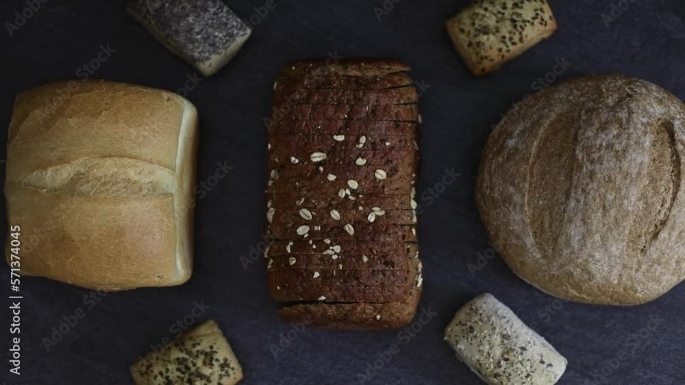 A lot of breads of different varieties, sizes, shapes and buns with ...
