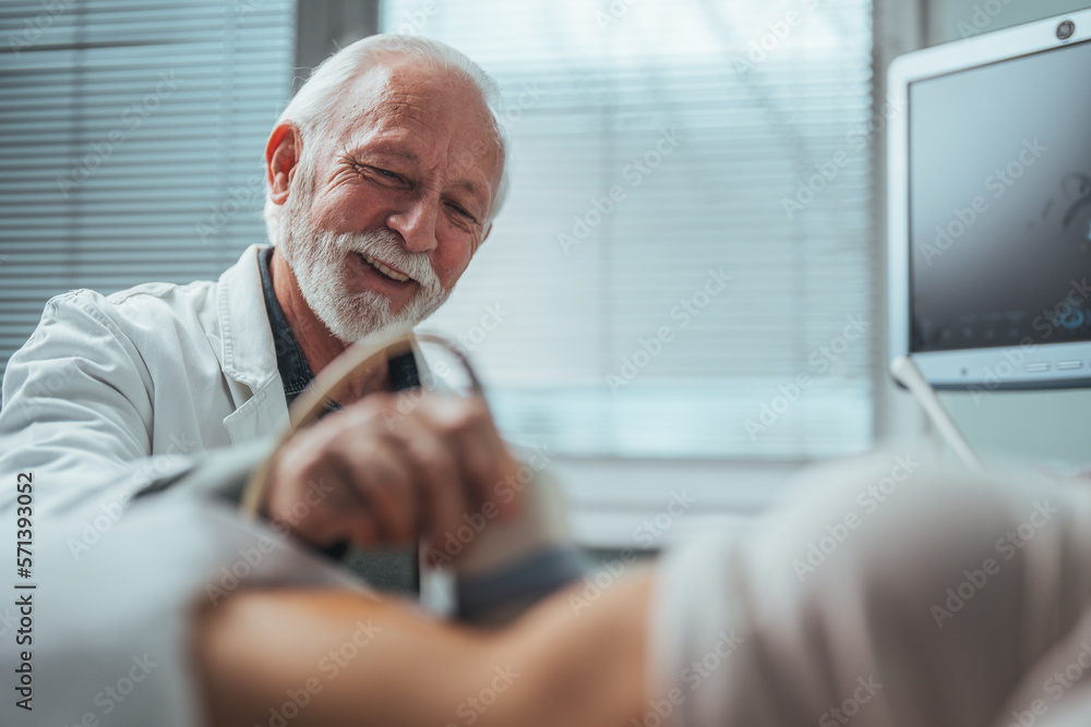 Sonographer using ultrasound machine at work. Modern clinical ...