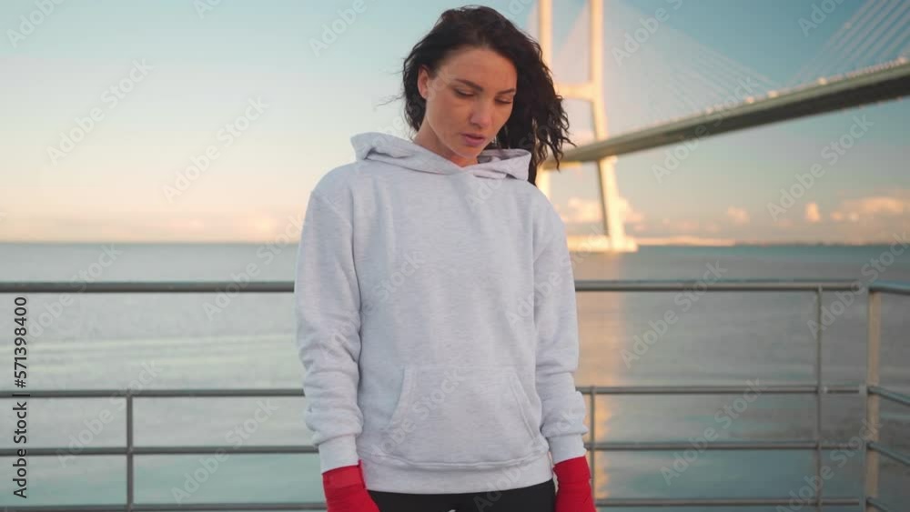 Female boxer in fighting stance staring into the frame, looking in ...