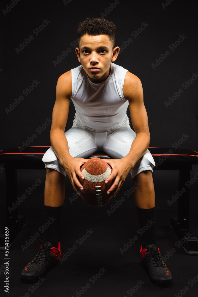 Young Youth Preteen Boy Football Player Sitting with Football on Bench ...