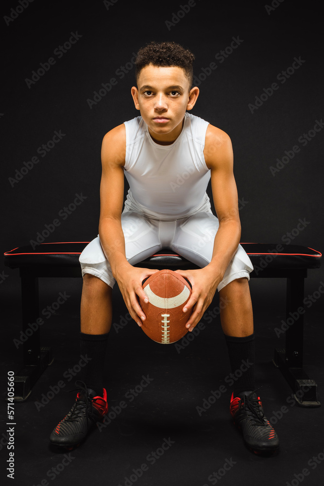 Young Youth Preteen Boy Football Player Sitting with Football on Bench ...