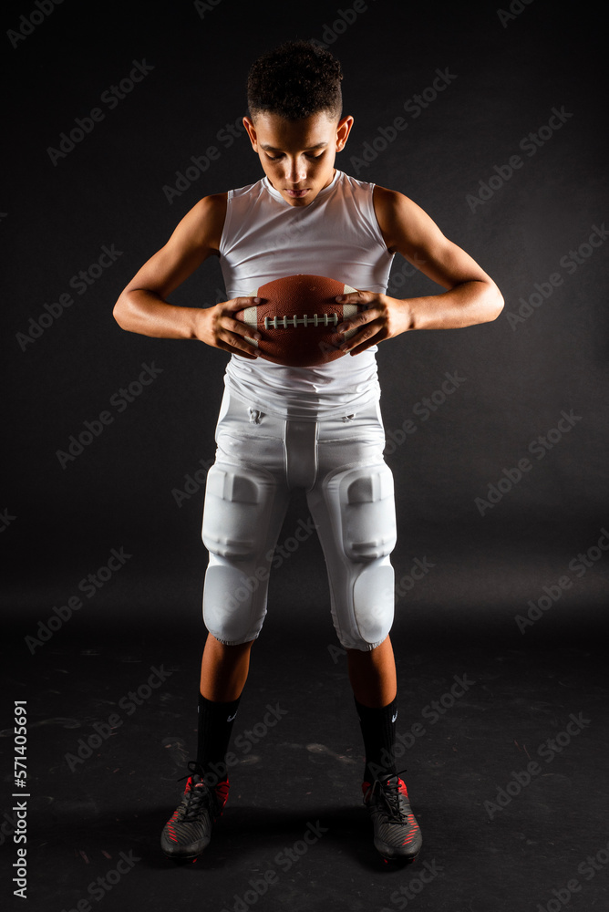 Youth Preteen Boy Football Player Holding Football in Studio Stock ...