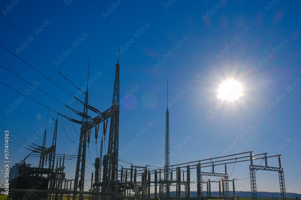 Power station and sun on a blue sky background.Energy equipment.High ...