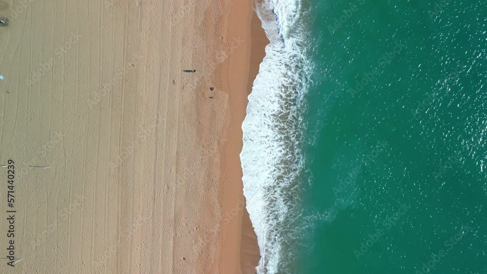 Soaring high above a golden sand beach with turquoise blue waters, the ...