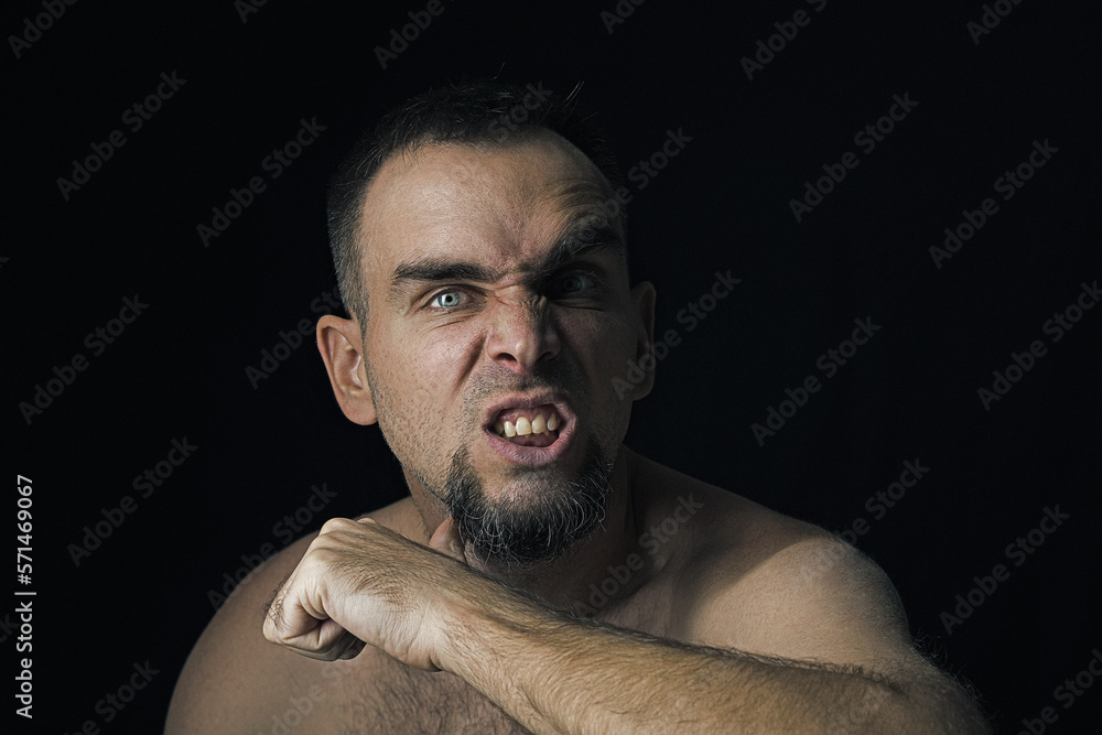 A man with an angry expression on his face, a man threatening with his ...