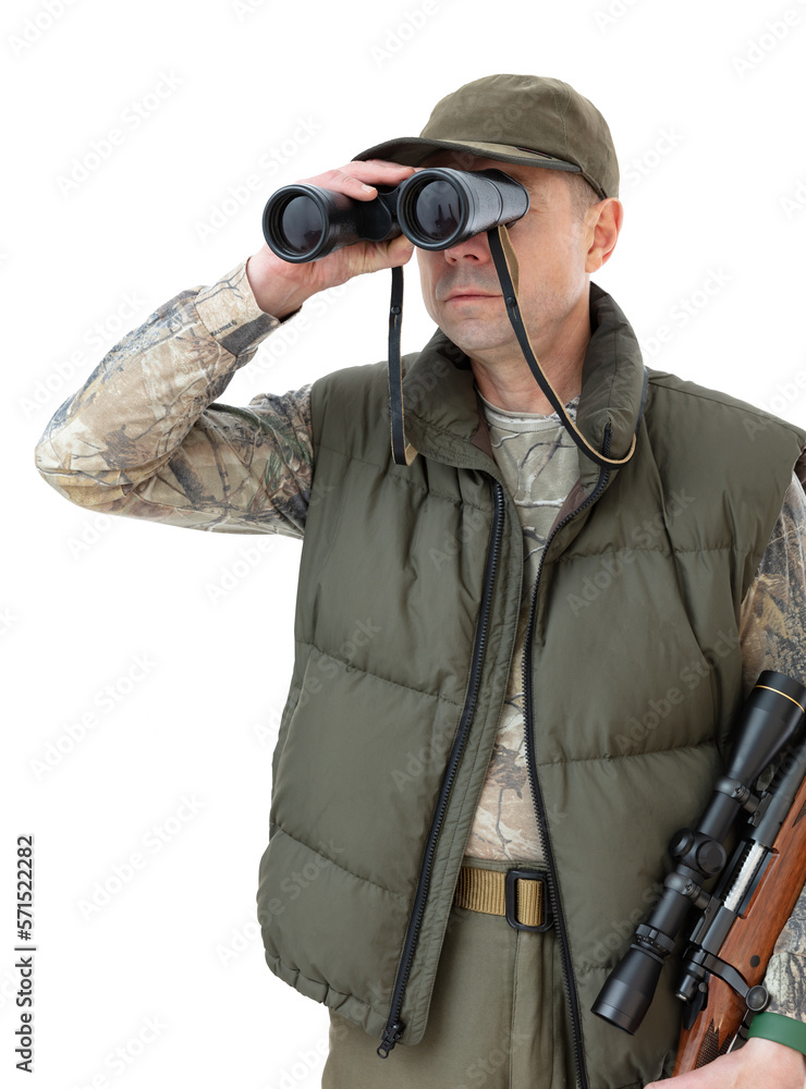 Fifty-year-old man in hunting uniform looks through binoculars ...