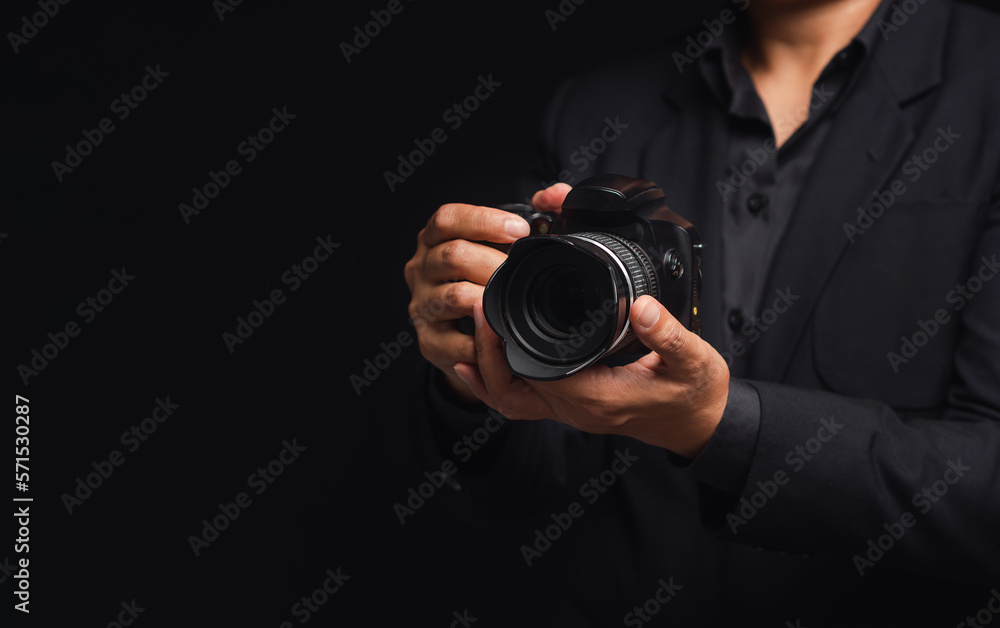 Photographer in a suit holding the digital camera while standing on a ...