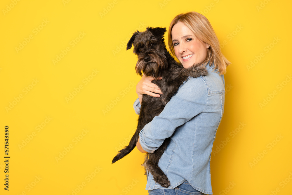 Cute young woman hugs her puppy schnauzer dog. Love between owner and ...