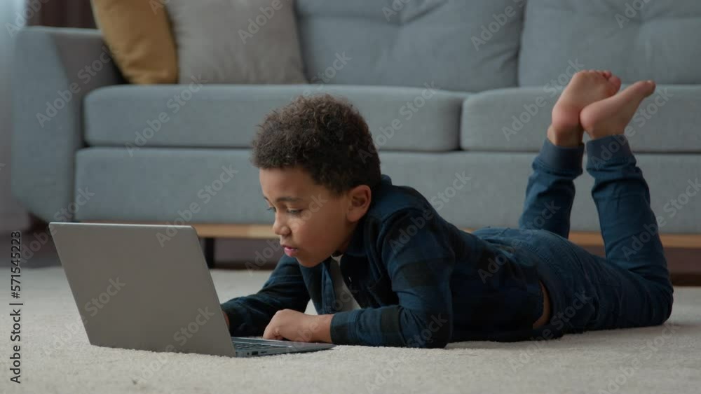 African American kid boy ethnic school pupil studying online from home ...